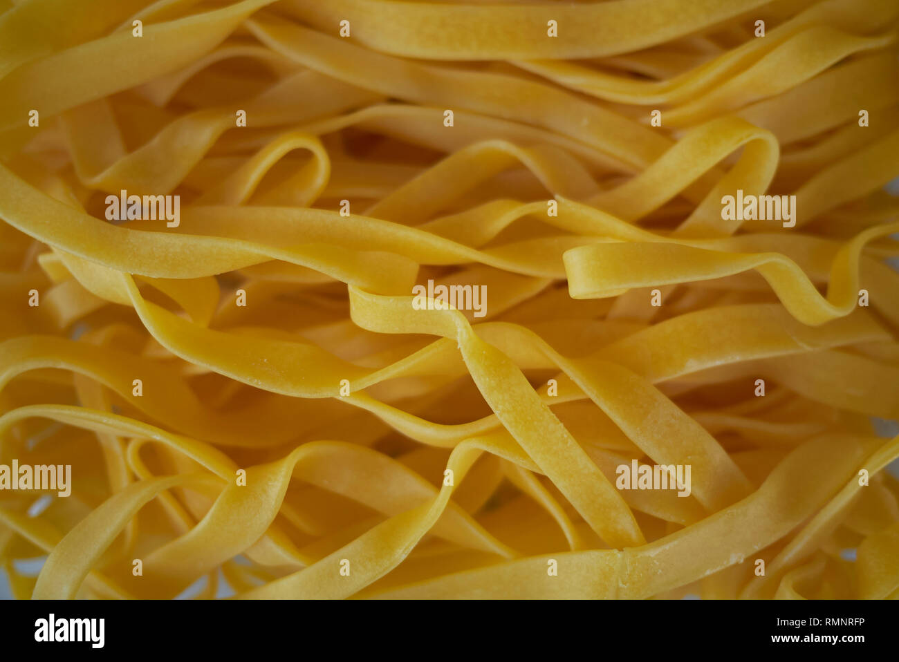 Raw tagliatelle pasta Stock Photo - Alamy