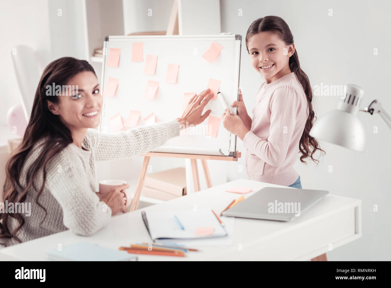 Family duties. Disciplined good-looking mother distributing family ...