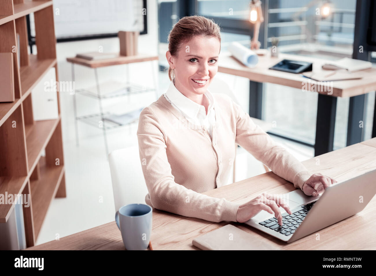 Video interview. Pretty charming remote worker feeling joyful while ...