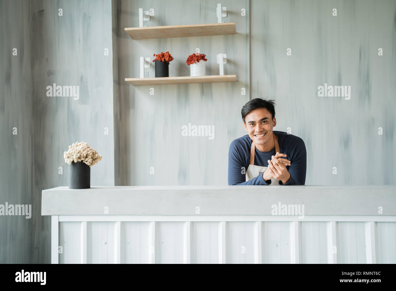 asian male waitress looking at camera and smiling. portrait of cafe ...