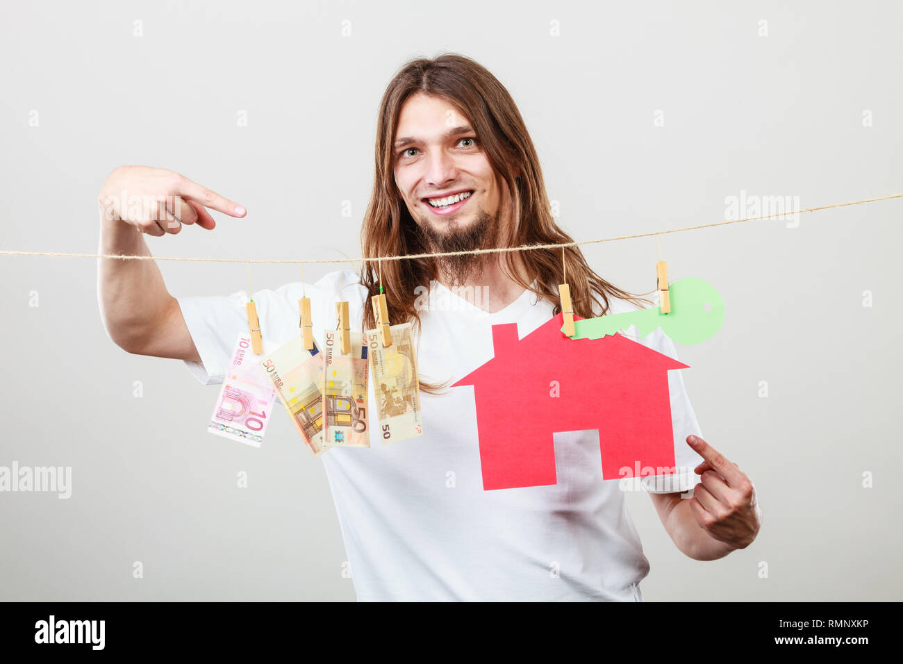 Concept of real estate and deal. Seller man with house model and ...