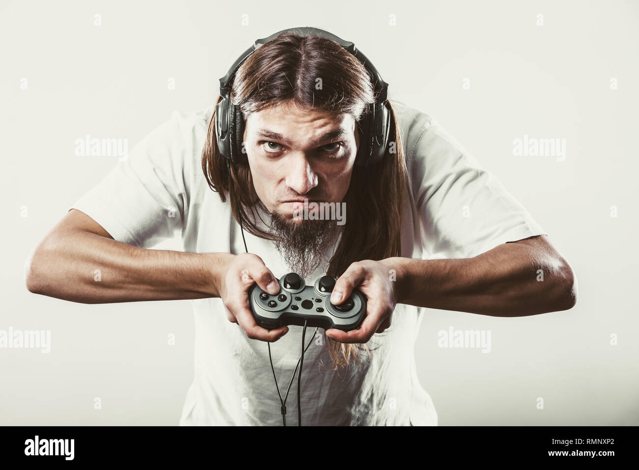 Addiction. Stressed depressed young man playing gaming on pad. Angry ...