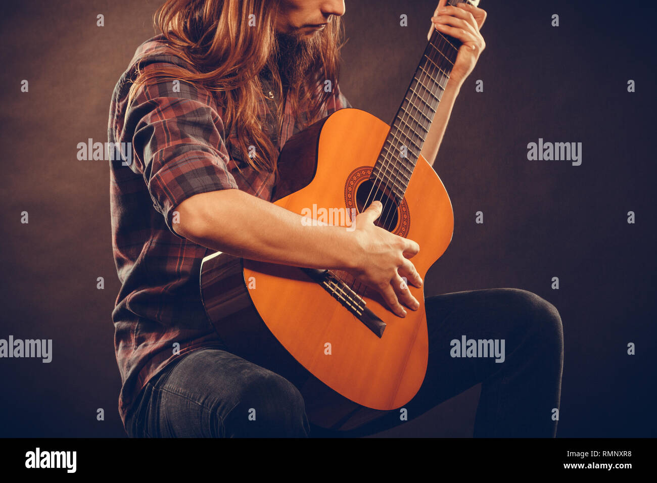 Hobby passion concept. Guitarist is playing the guitar. Long haired ...