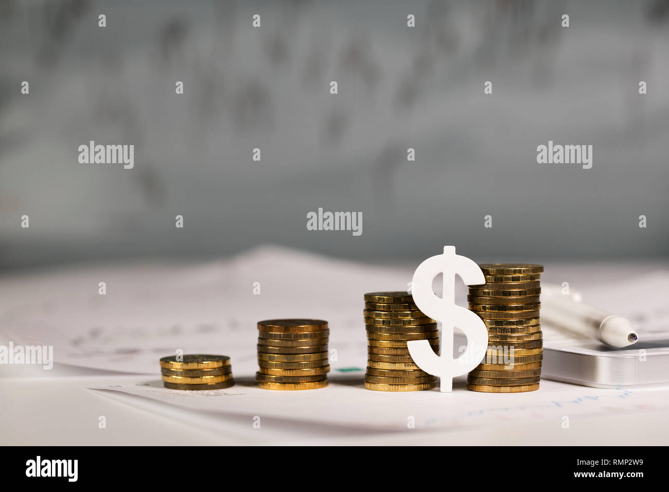 Cutouts of American dollar sign at stacks of coins. Stock market ...