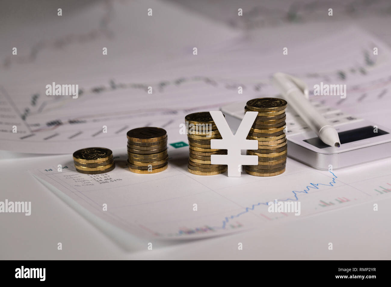 Paper sign of Chinese yuan at stack of Russian 10 roubles coins ...