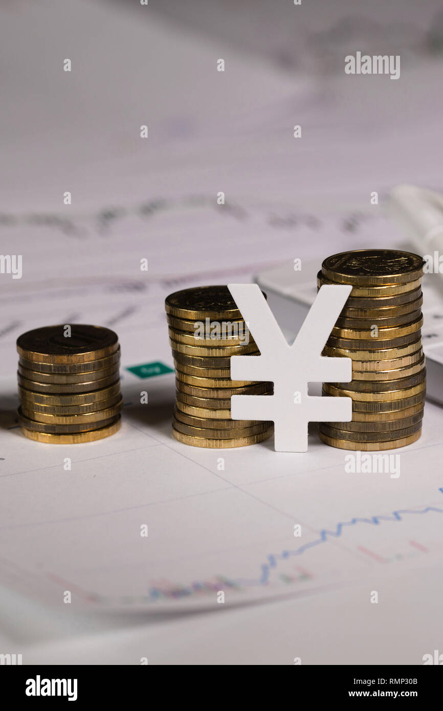 Paper sign of Chinese yuan at stack of Russian 10 roubles coins ...