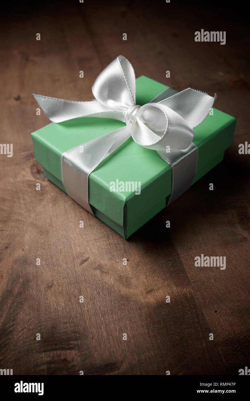 Luxury box tied with a white ribbon Stock Photo - Alamy