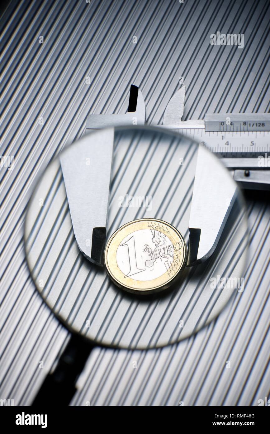 metal gauge measuring a one euro coin on a metal surface Stock Photo ...