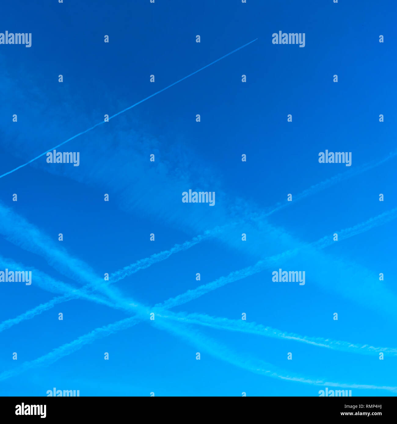 Blue sky with crossing condensation trails hi-res stock photography and ...