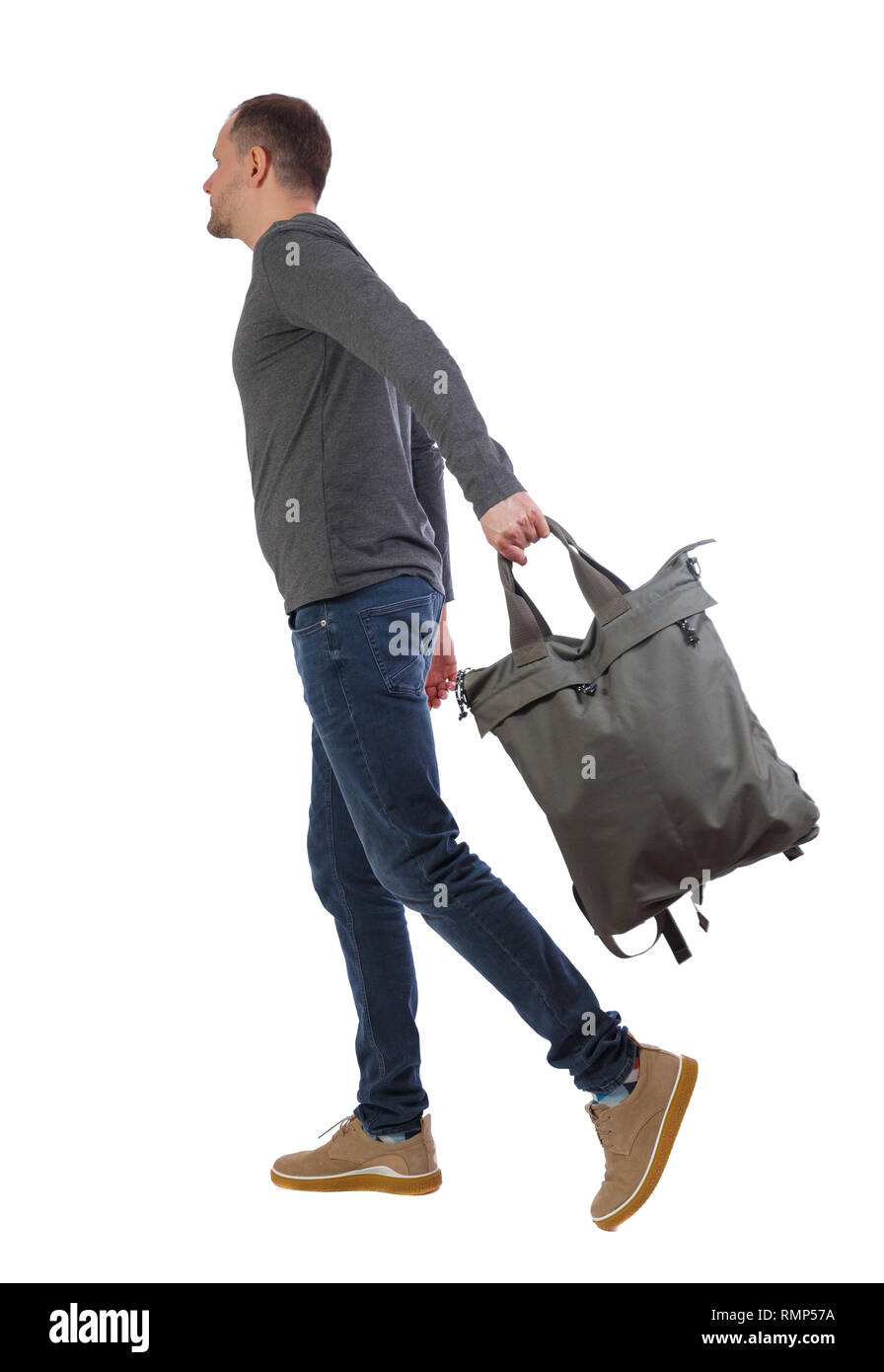 Side view of walking man with green bag. backside view of person. Rear ...