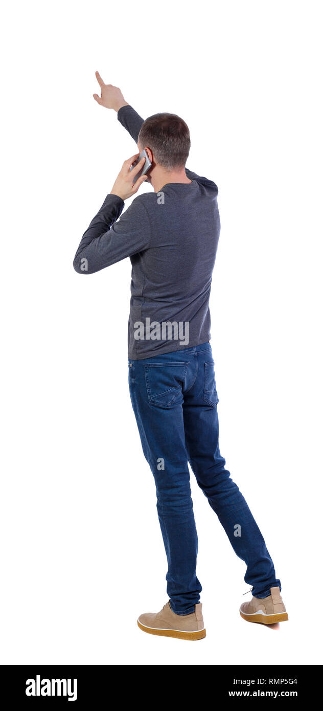 Back view of pointing young men talking on cell phone. Young guy ...