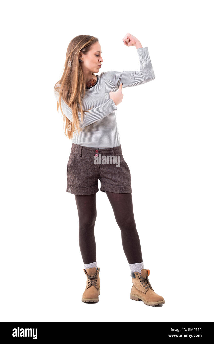 Girl power concept. Slim pretty young woman flexing slim arm bicep ...
