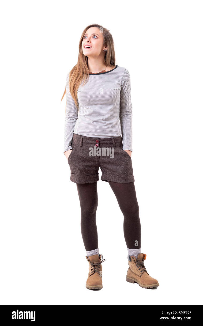 Amazed surprised wide-eyed young pretty woman looking up. Full body ...