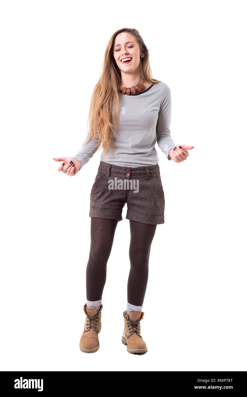 Confused young cute stylish woman laughing while talking with closed ...