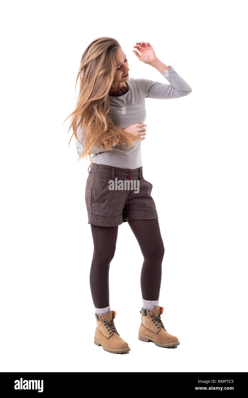 Relaxed young stylish woman in morning routine adjusting her long ...