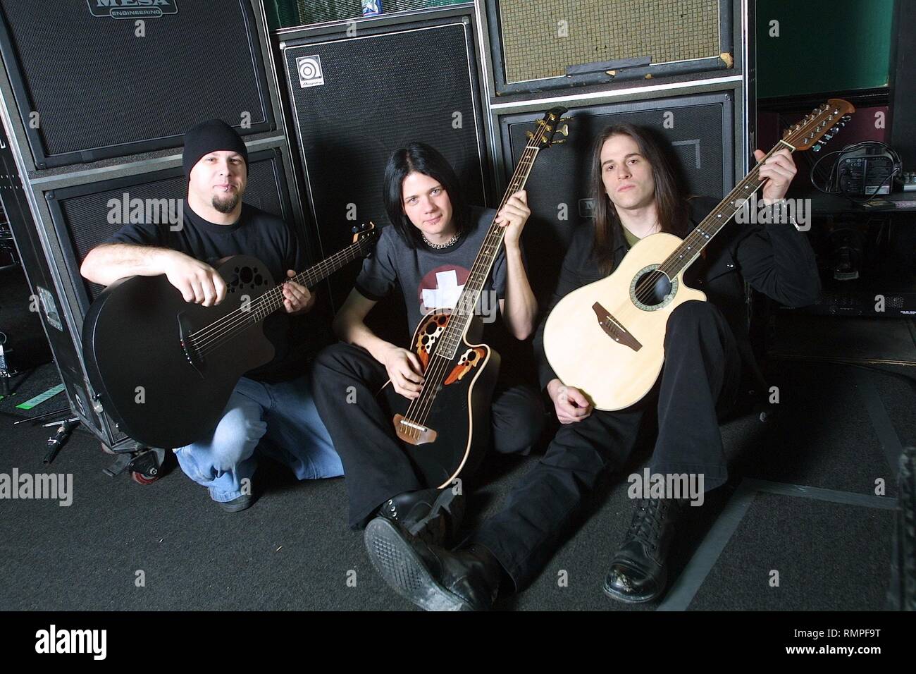 Soil band members are shown posing with their acoustic guitars and ...