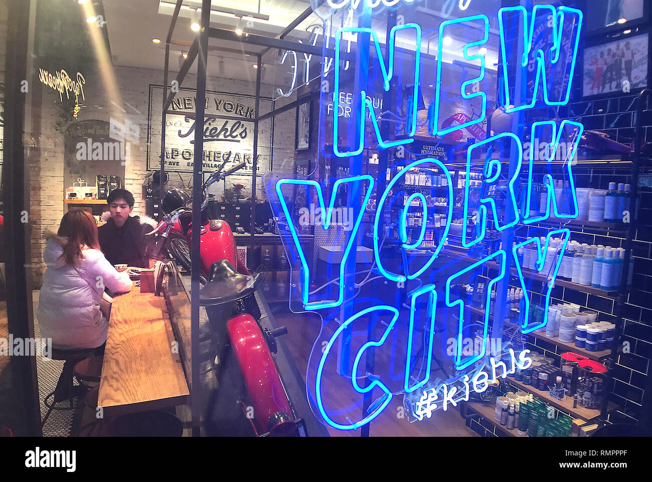 Beijing, China. 24th Jan, 2018. A Chinese couple eats at a new cafe and ...