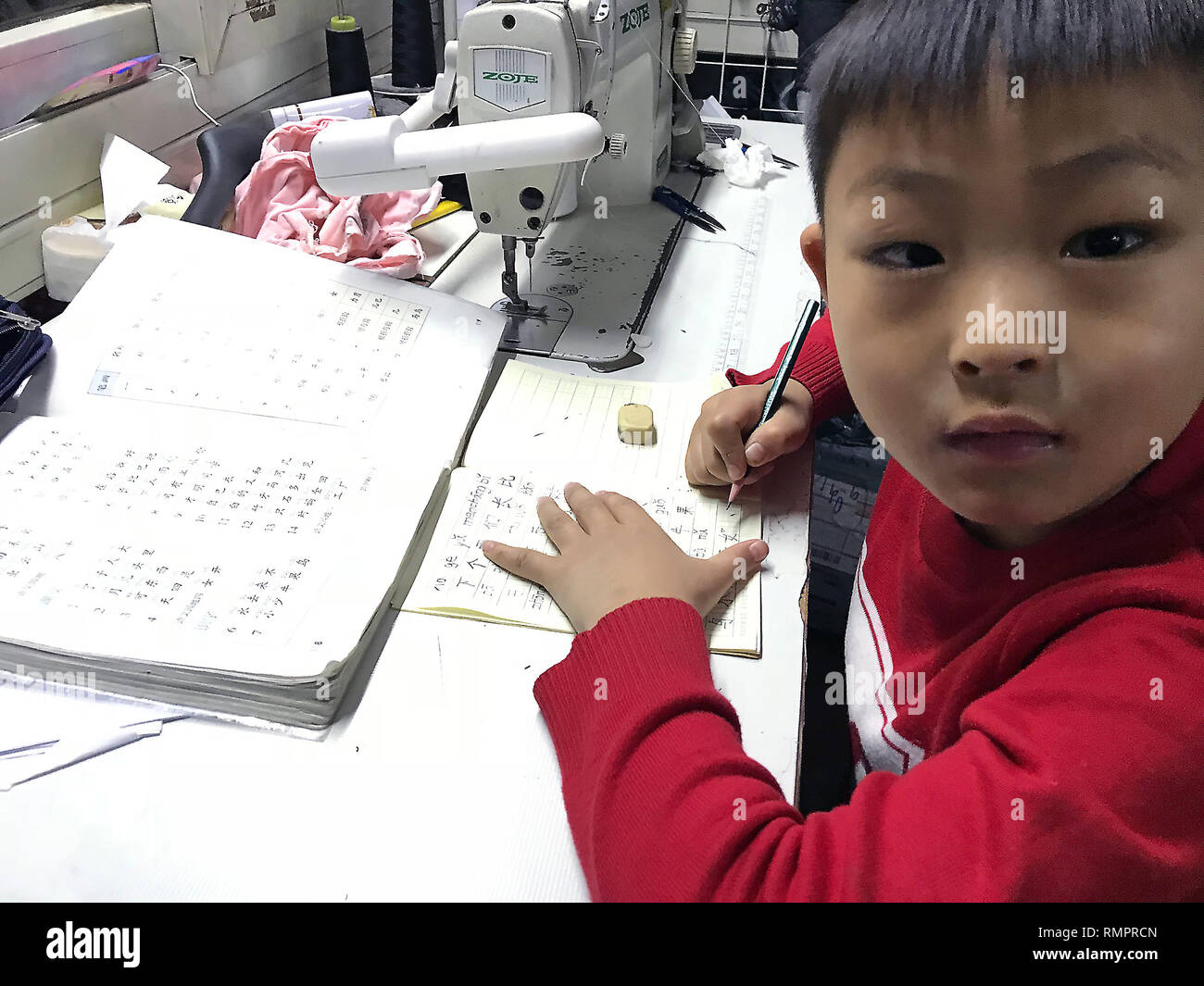 Beijing, China. 21st Jan, 2018. A young Chinese boy does his homework ...