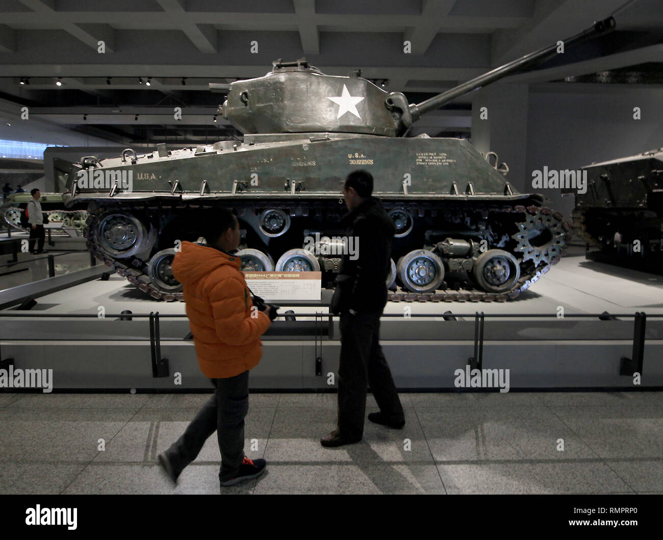 Beijing, China. 6th Feb, 2018. Chinese visitors look at a U.S. Sherman ...