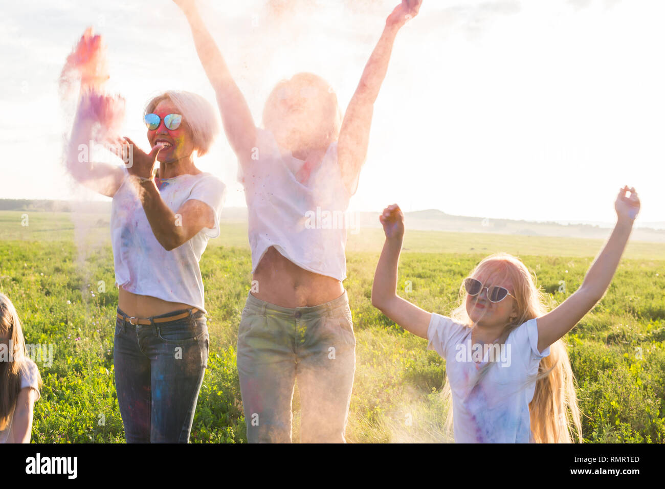 Indian holidays, fun and Holi festival concept - Jumping happy women ...