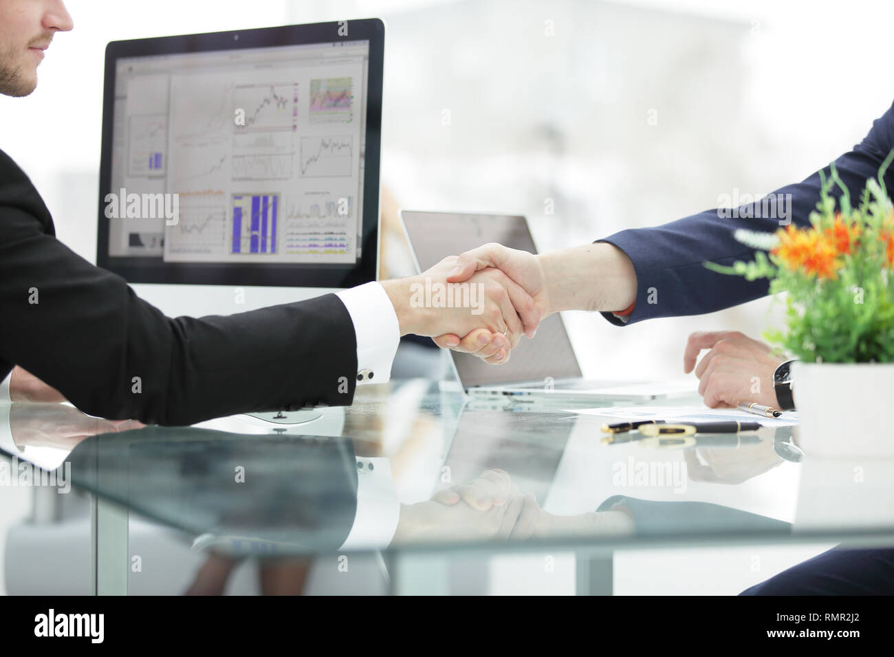 close up.the background image of a handshake over the Desk Stock Photo ...