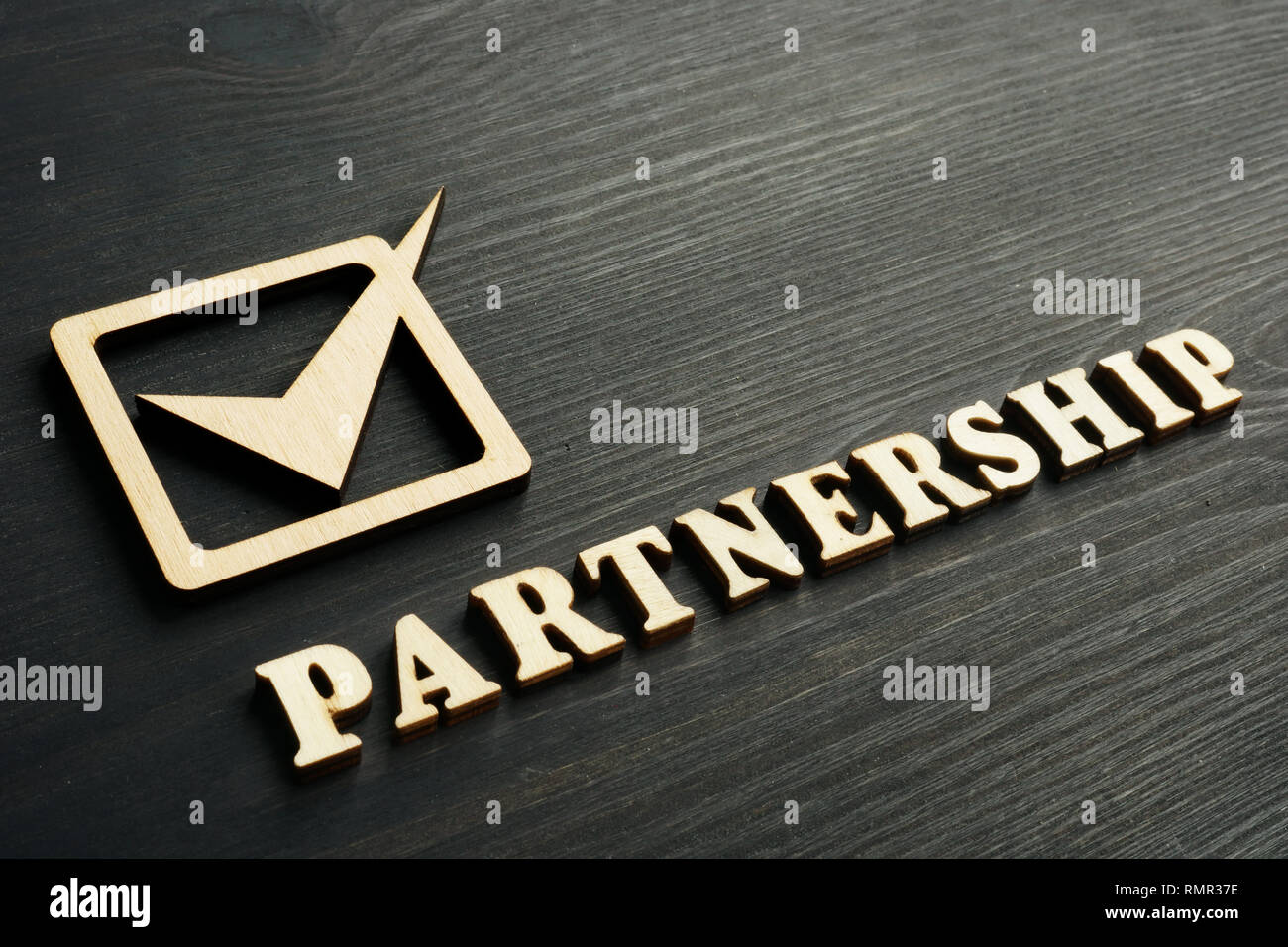 Partnership concept. Wooden letters on a desk Stock Photo - Alamy
