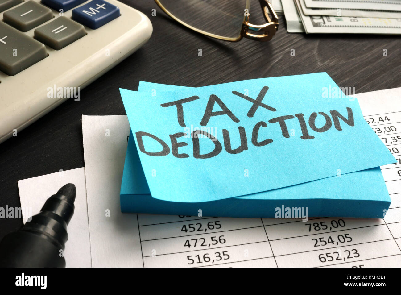Tax deduction written on a piece of paper Stock Photo - Alamy