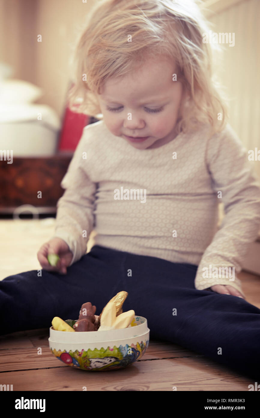 Toddler girl having a snack Stock Photo - Alamy