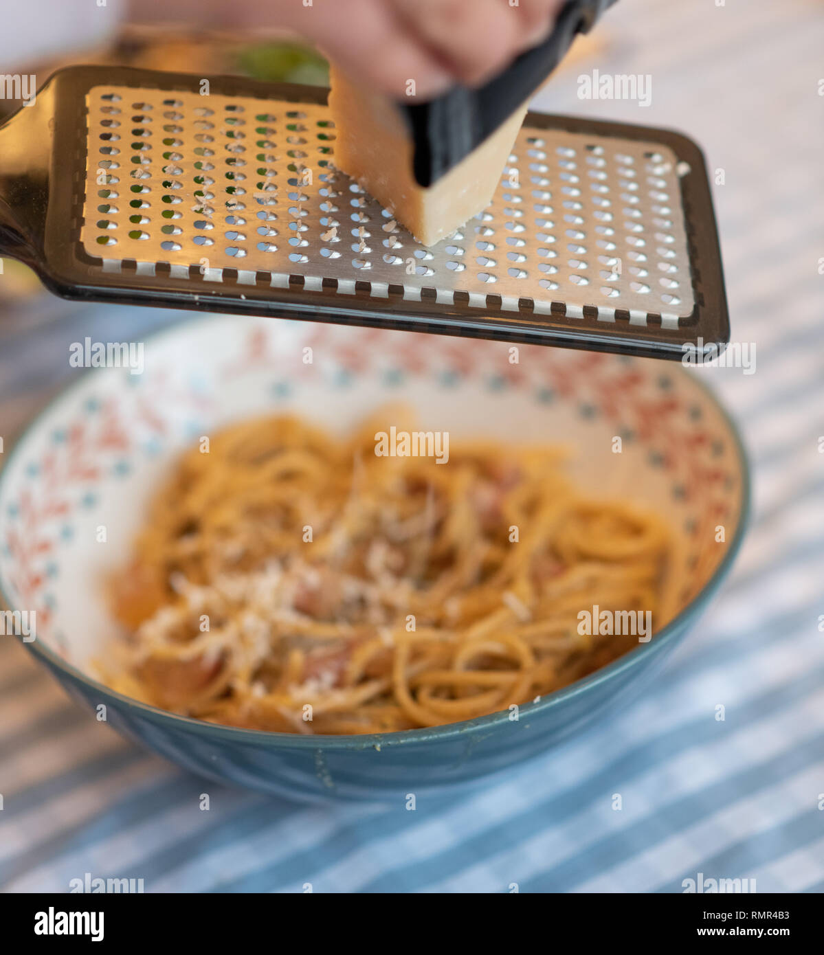grinding parmesan cheese to carbonara Stock Photo - Alamy