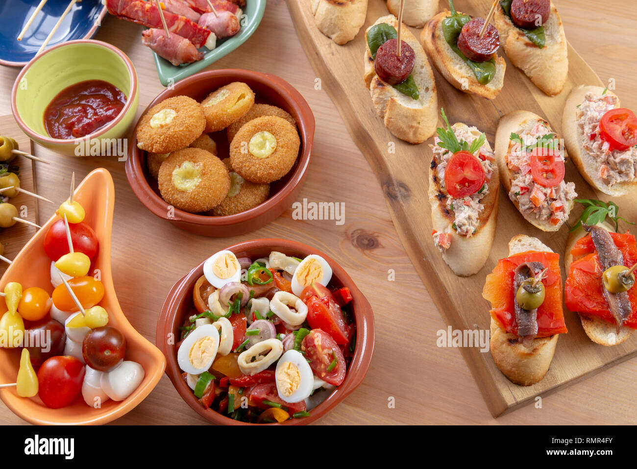Top view of a variety of snacks - spanish tapas or italian antipasti ...