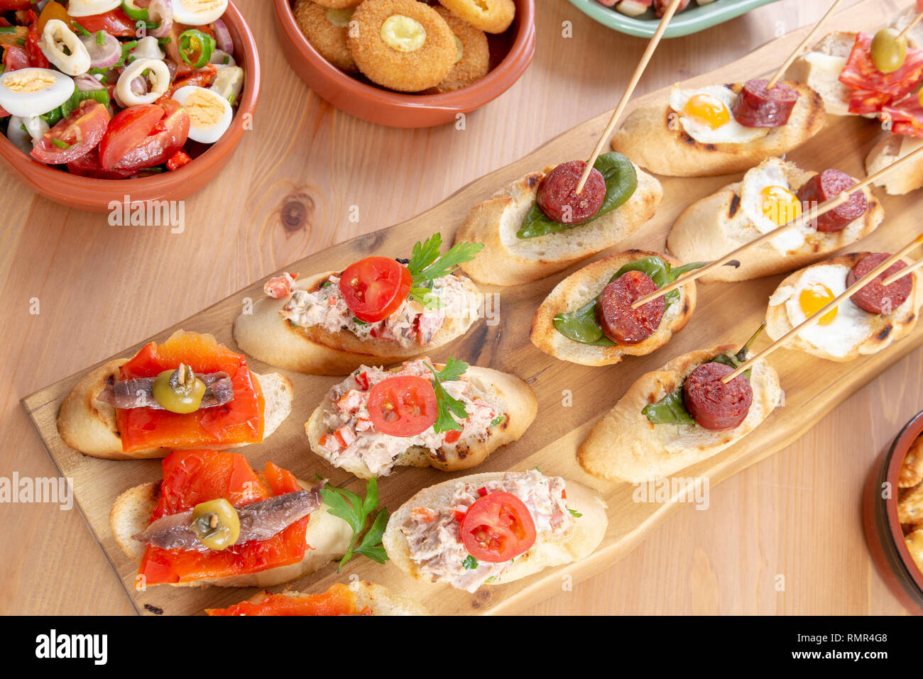 Top view of a variety of snacks - spanish tapas or italian antipasti ...