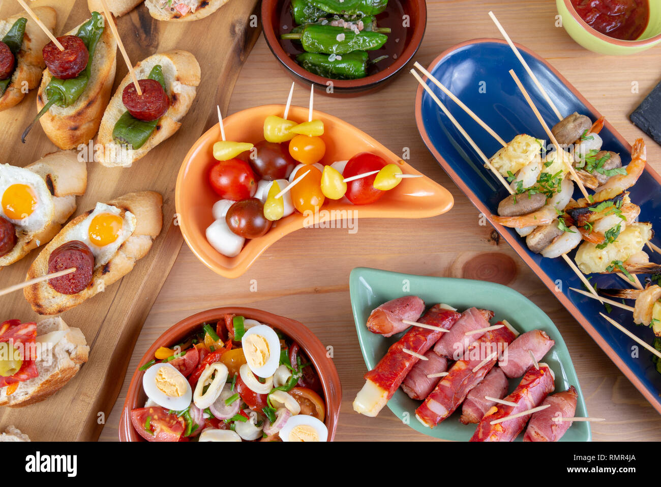 Top view of a variety of snacks - spanish tapas or italian antipasti ...