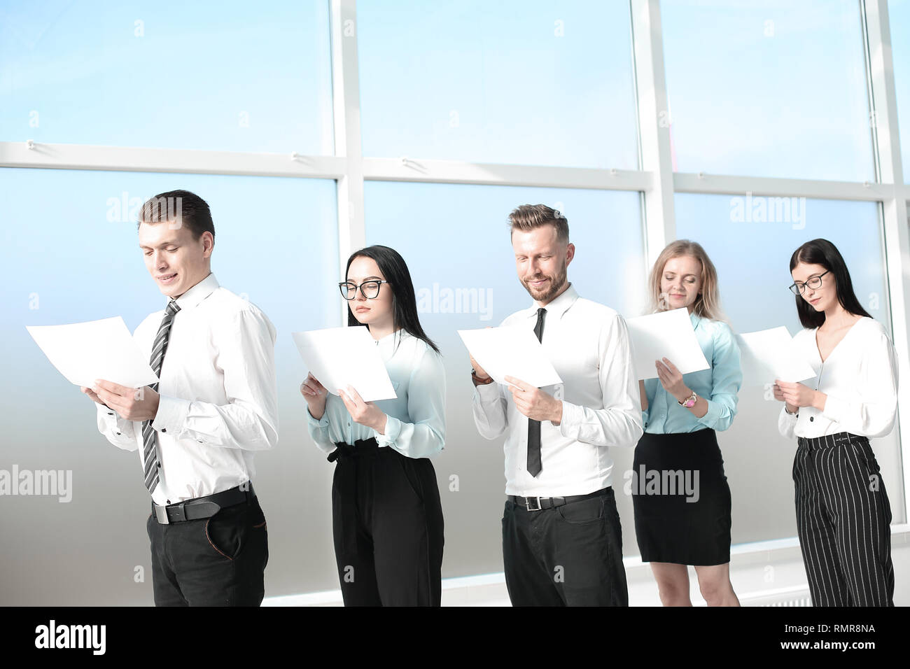 employees with business documents standing in the office hallway Stock ...