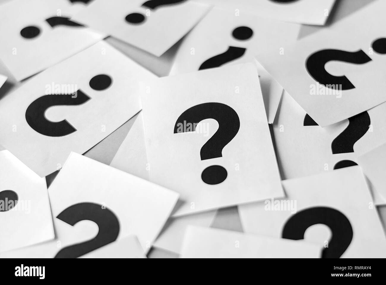Pile of white cards with black question marks viewed in full frame ...