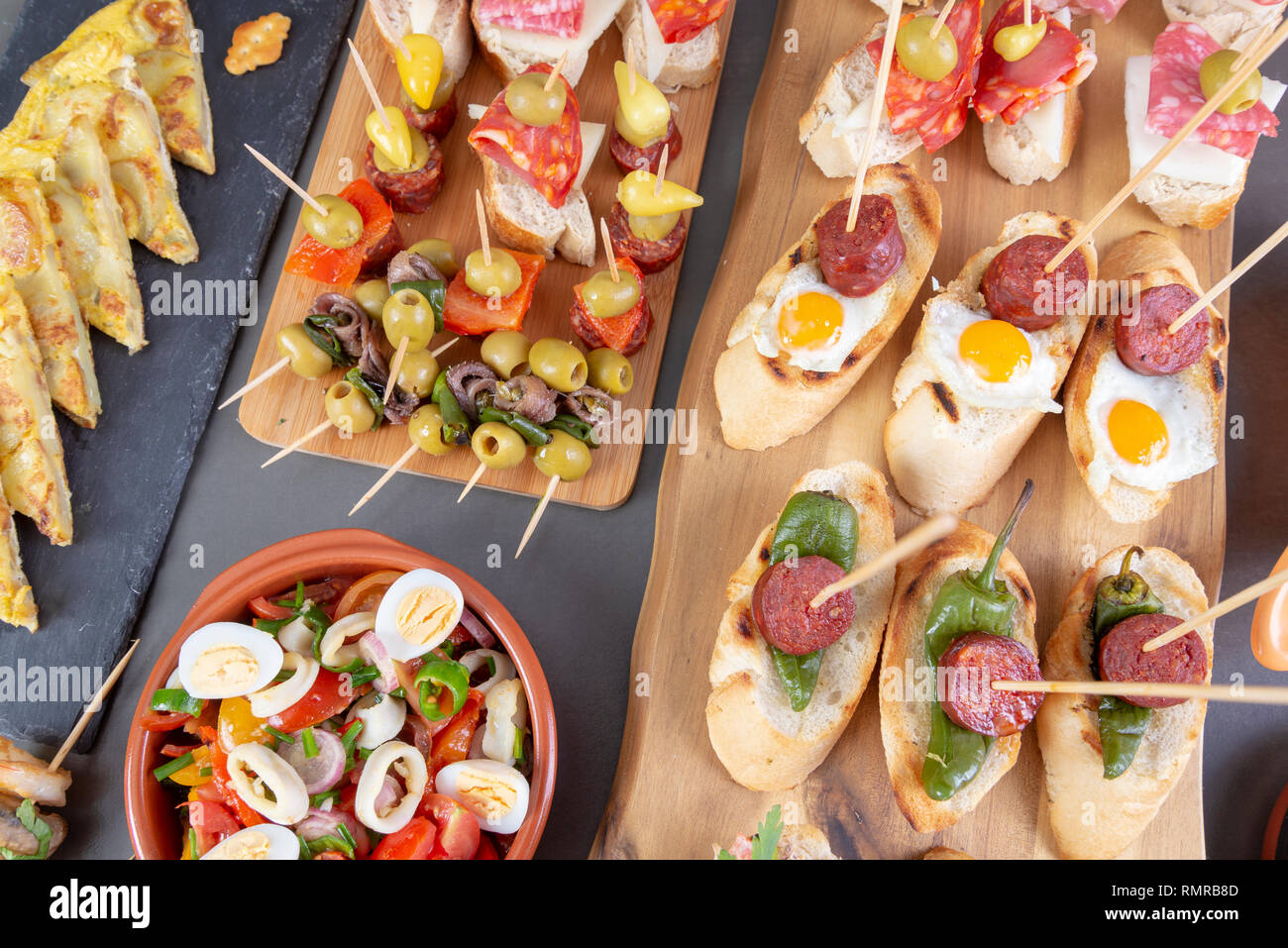 Top view of Spanish tapas snacks with olives, anchovies, tortilla ...