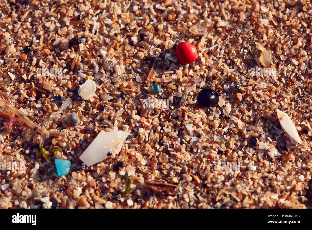 two micro plastic nurdles on sand Stock Photo - Alamy
