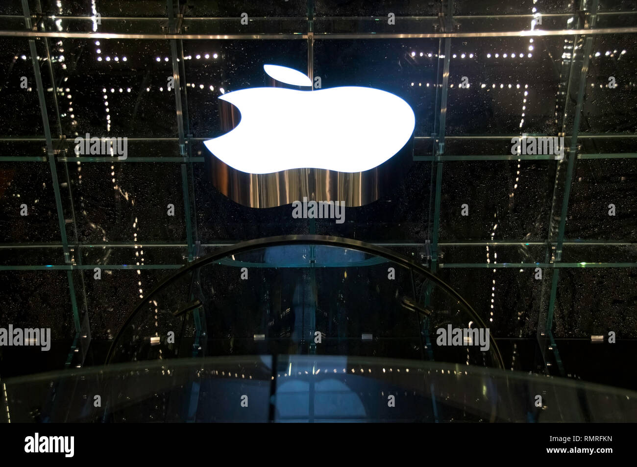 The lighted white logo of Apple at a flagship store in New York City's ...