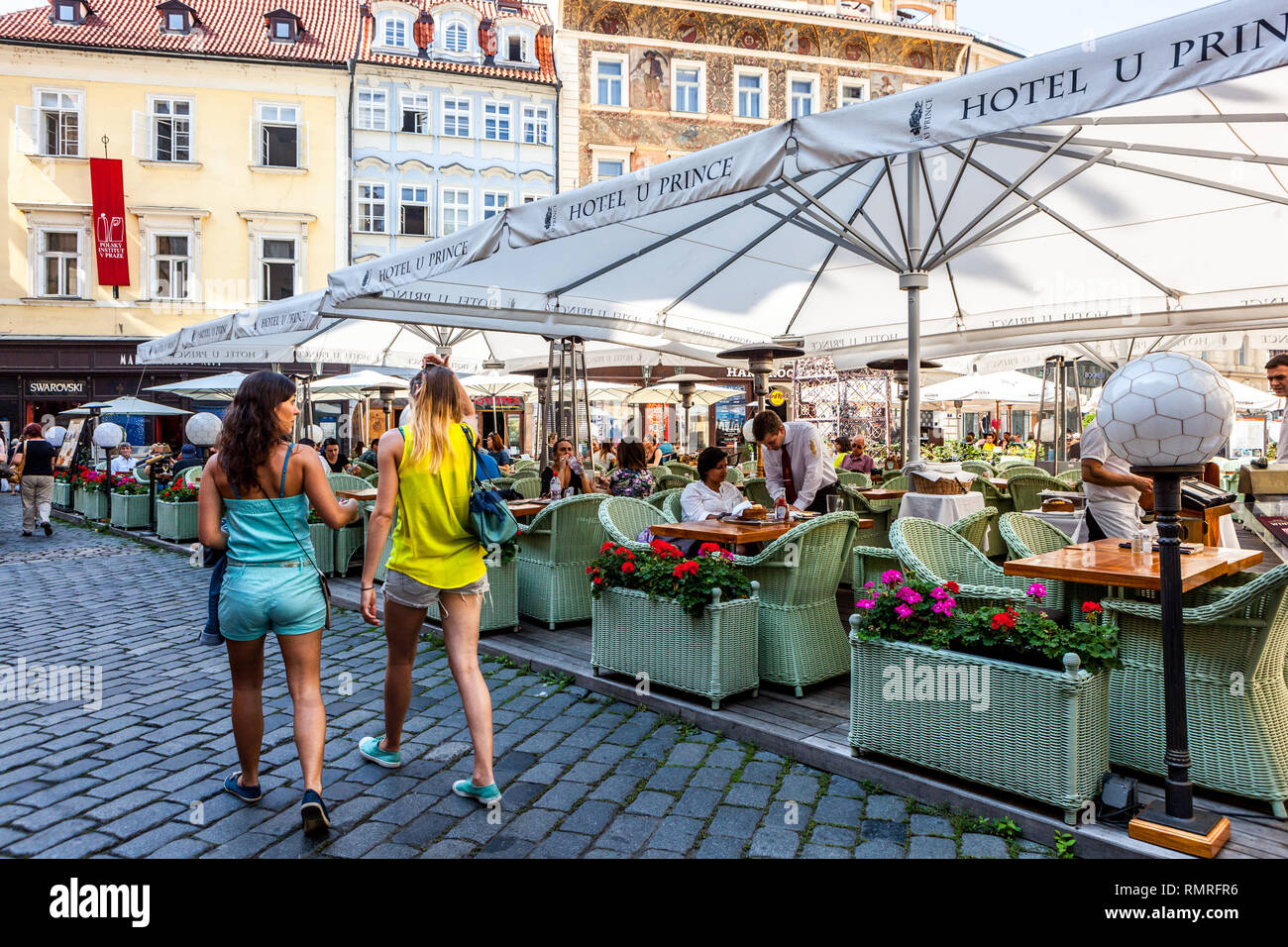 Two Prague tourists, women walk around the street bar U Prince, Male ...