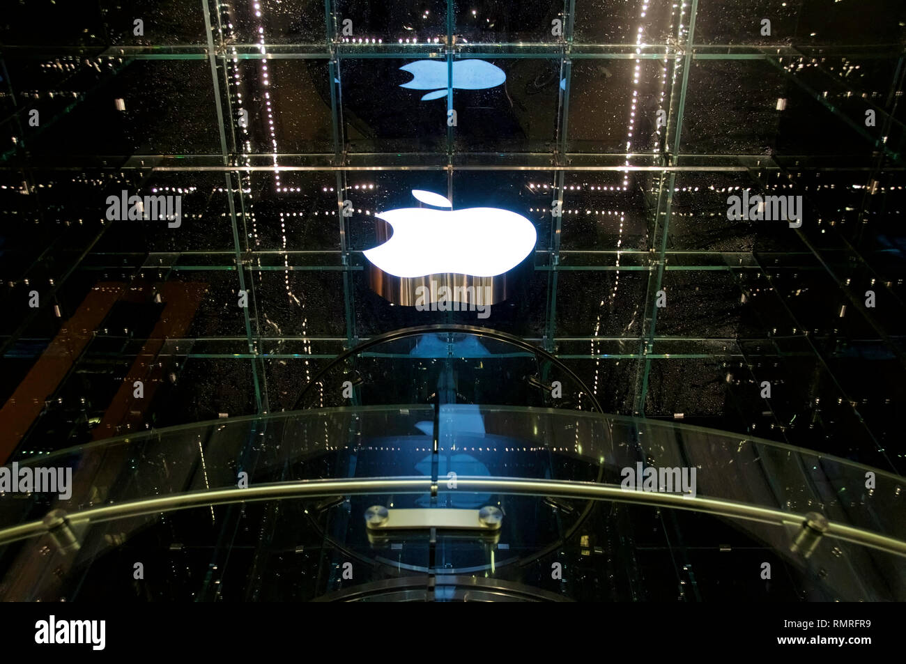 The lighted white logo of Apple at a flagship store in New York City's ...