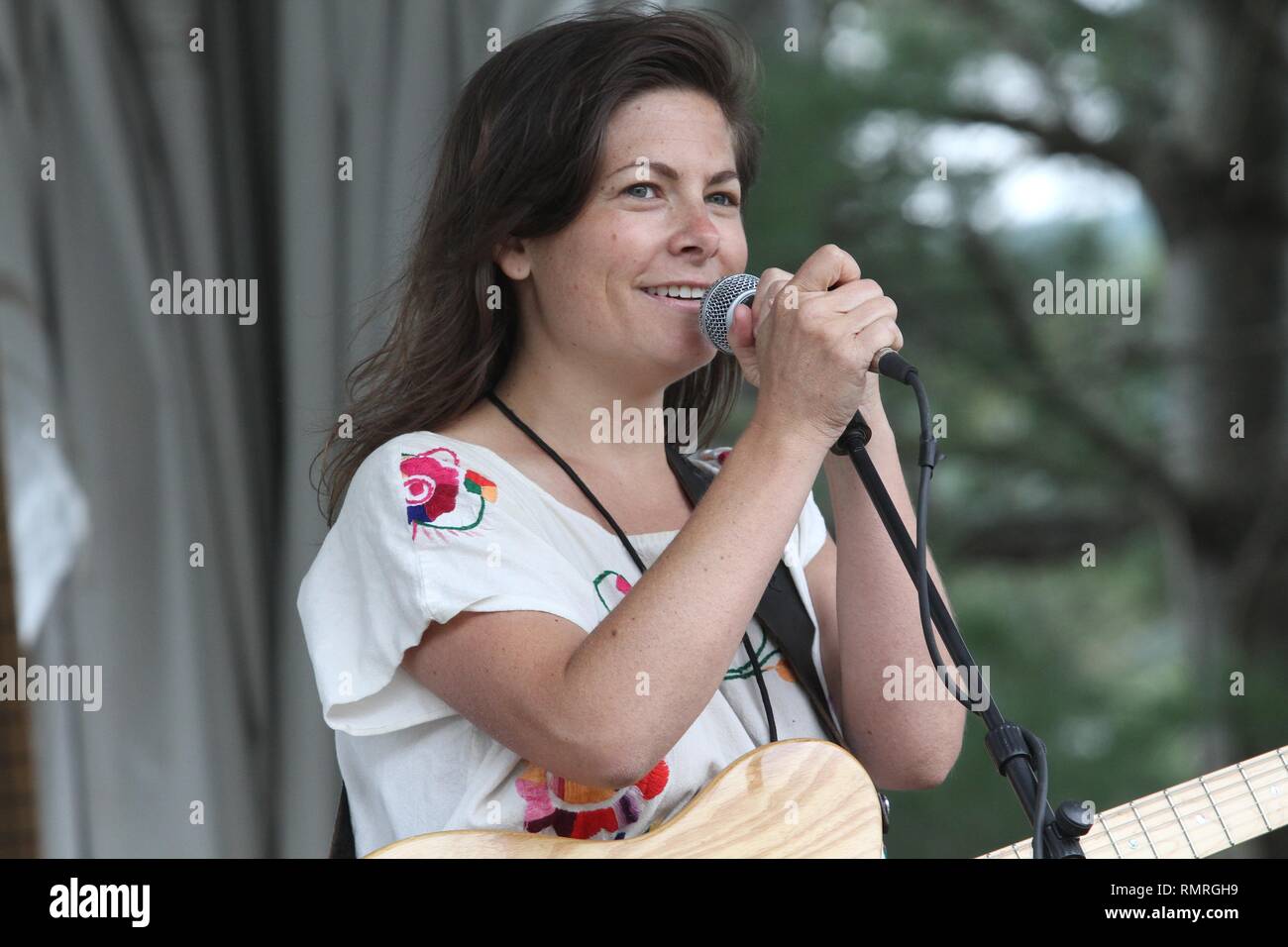 Musician Kelli Scarr is shown performing on stage during a "live ...