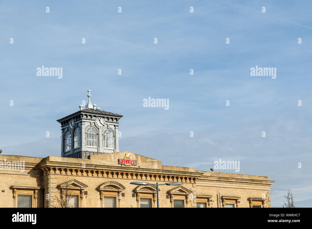 The clock tower above the Three Guineas pub outside Reading Station ...