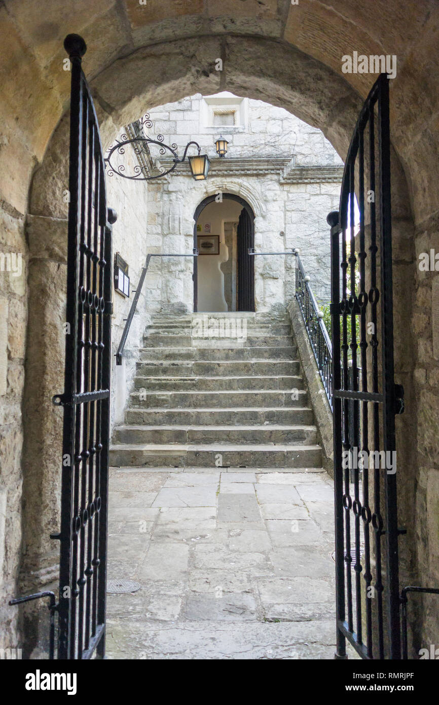 Ancient stone arch and gateway leading through to steps Stock Photo - Alamy