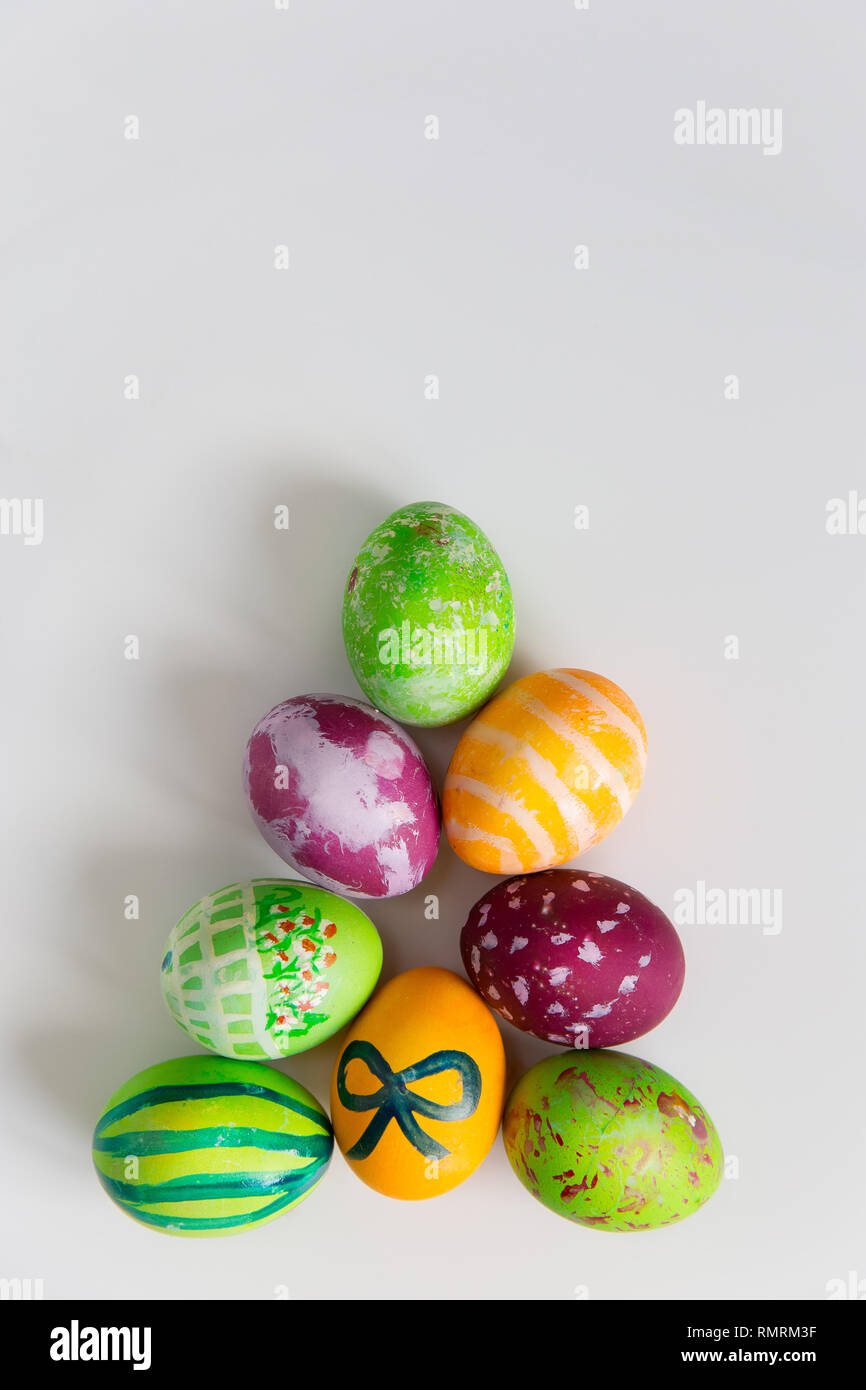Easter colorful eggs are laid in the shape of a pyramid on white ...