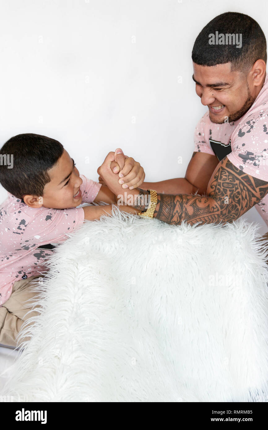 Strong, modern father and son in pink Stock Photo - Alamy