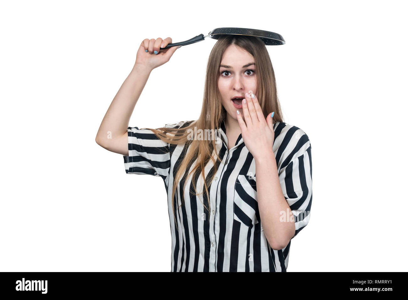 portrait of a beautiful surprised business woman with a frying pan on ...
