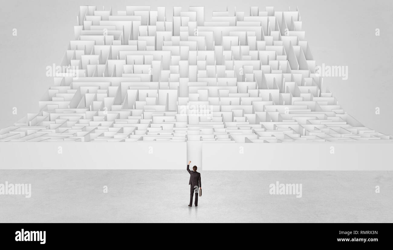 Businessman standing and thinking in front of a curved infinity maze ...