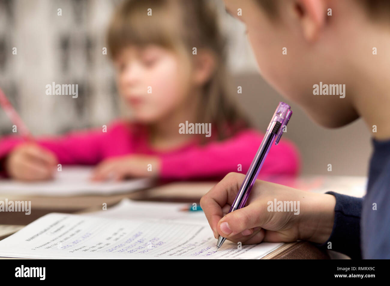 Two cute young children, boy and girl, brother and sister doing ...
