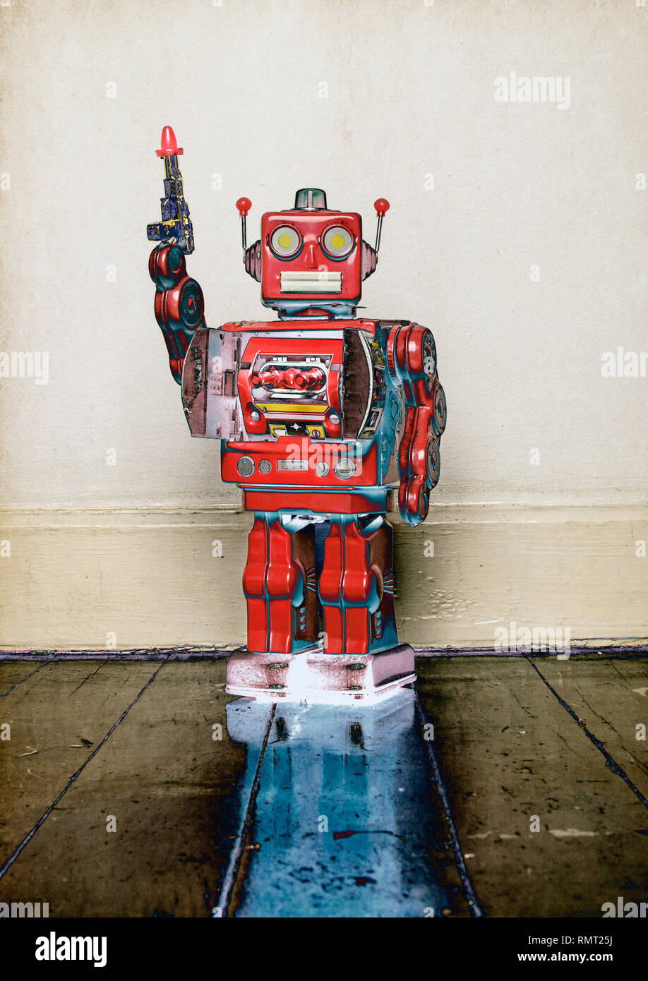 Shoot them up a vintage robot with a ray gun on a wooden floor ...