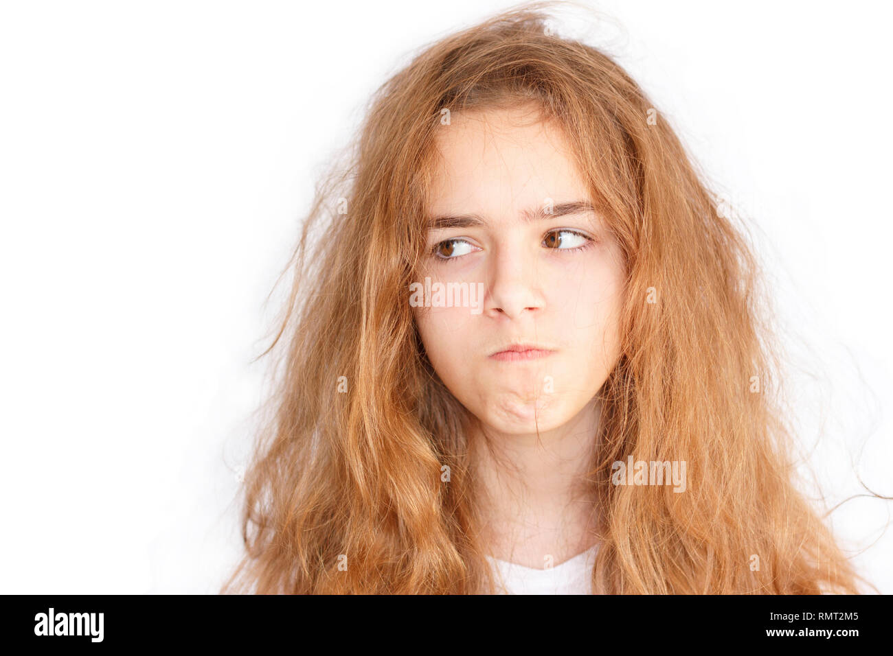 Pretty teenager girl with a long hair makes very angry funny face Stock ...