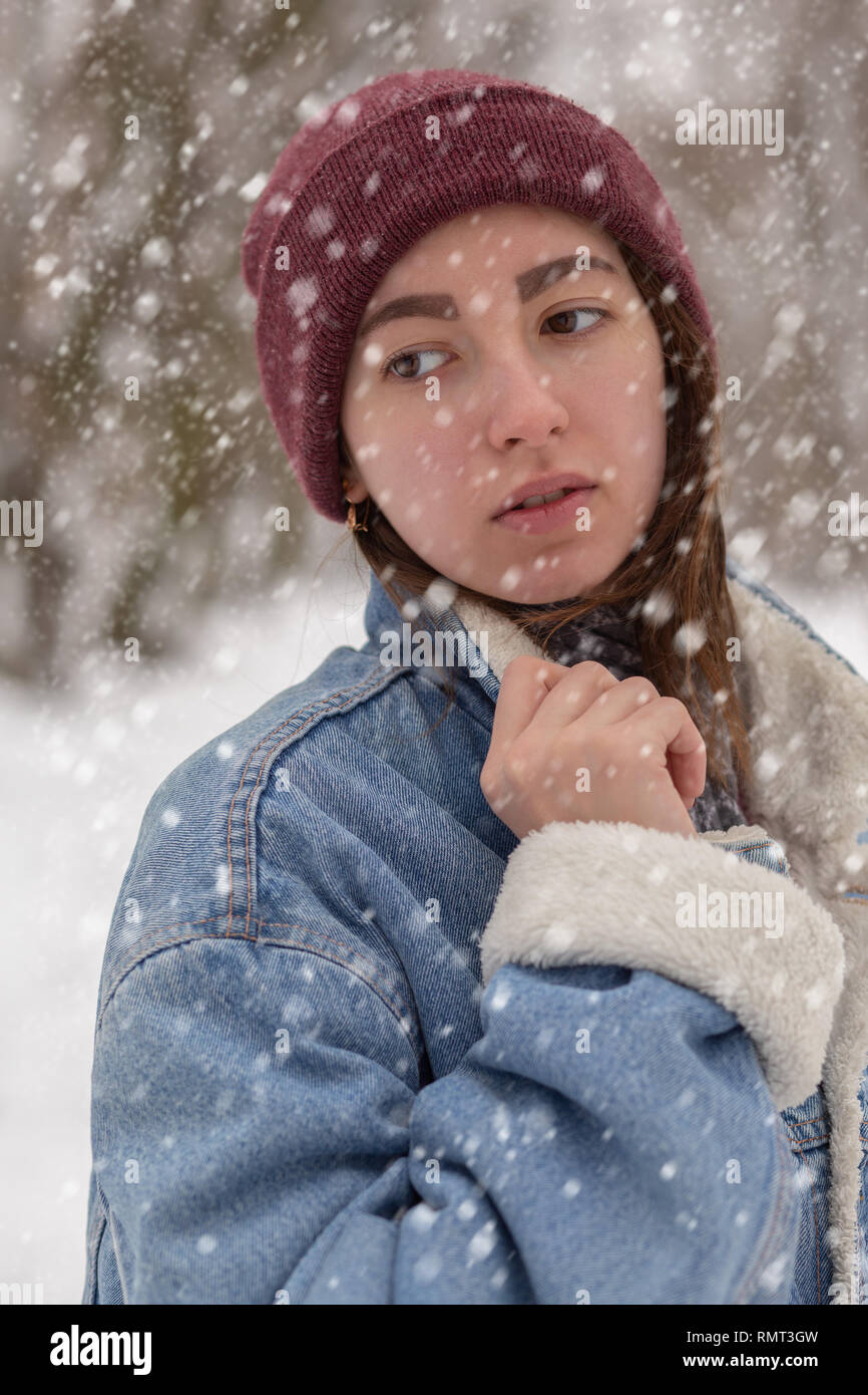 beautiful sad woman on winter forest under falling snow Stock Photo - Alamy